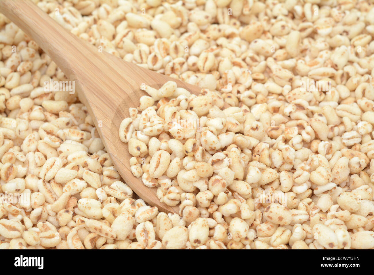 sweet popped rice on wooden spoon for background uses Stock Photo - Alamy