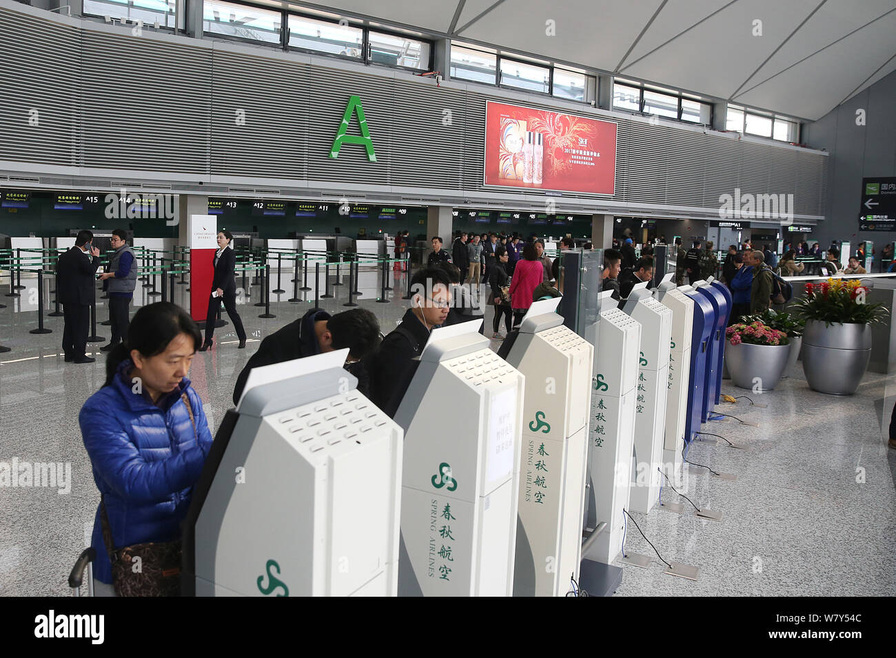 Chinese passengers operate machines of Spring Airlines to gets their ...