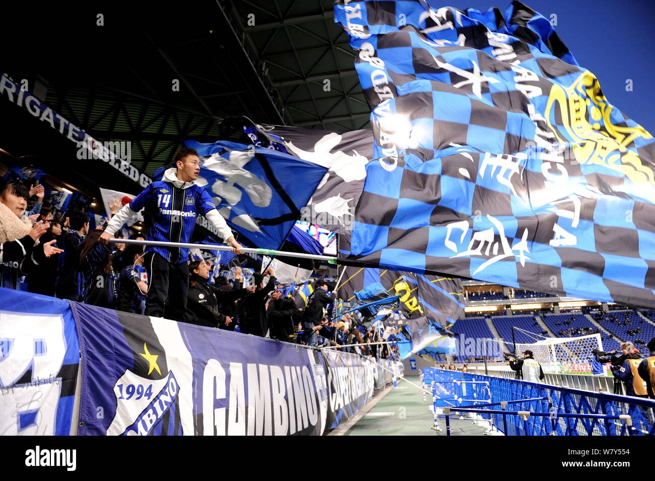 Football fans shout slogans to show support for Japan's Gamba Osaka in ...