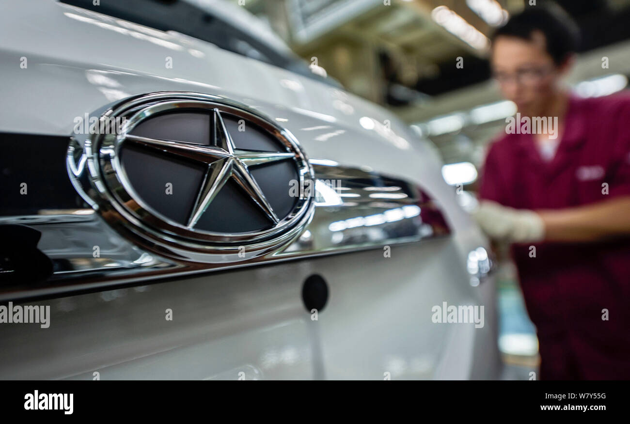 --FILE--A Chinese worker assembles a car on the assembly line at an ...