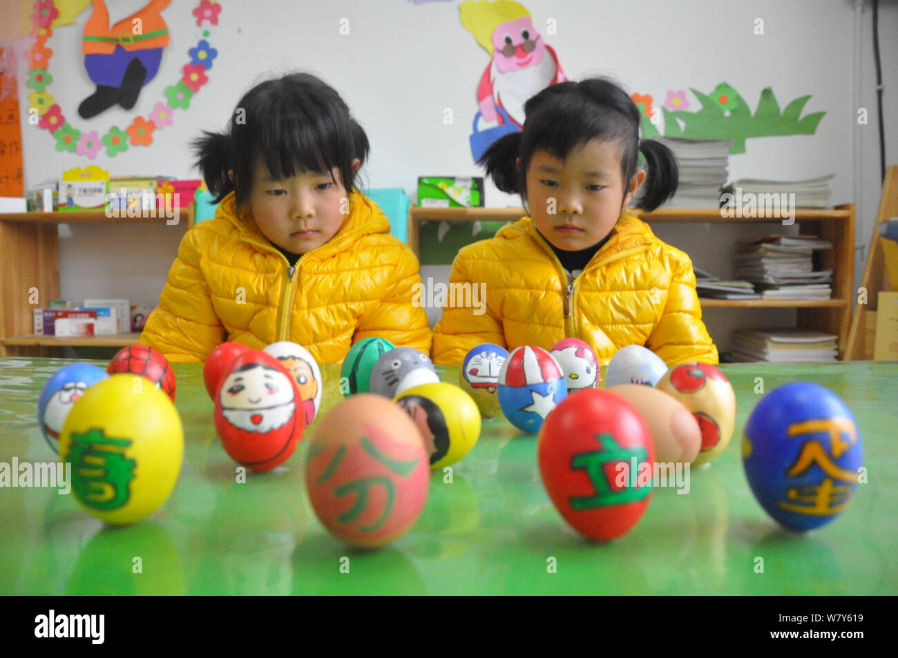 Chinese kids look at the eggs painted with Chinese characters for ...