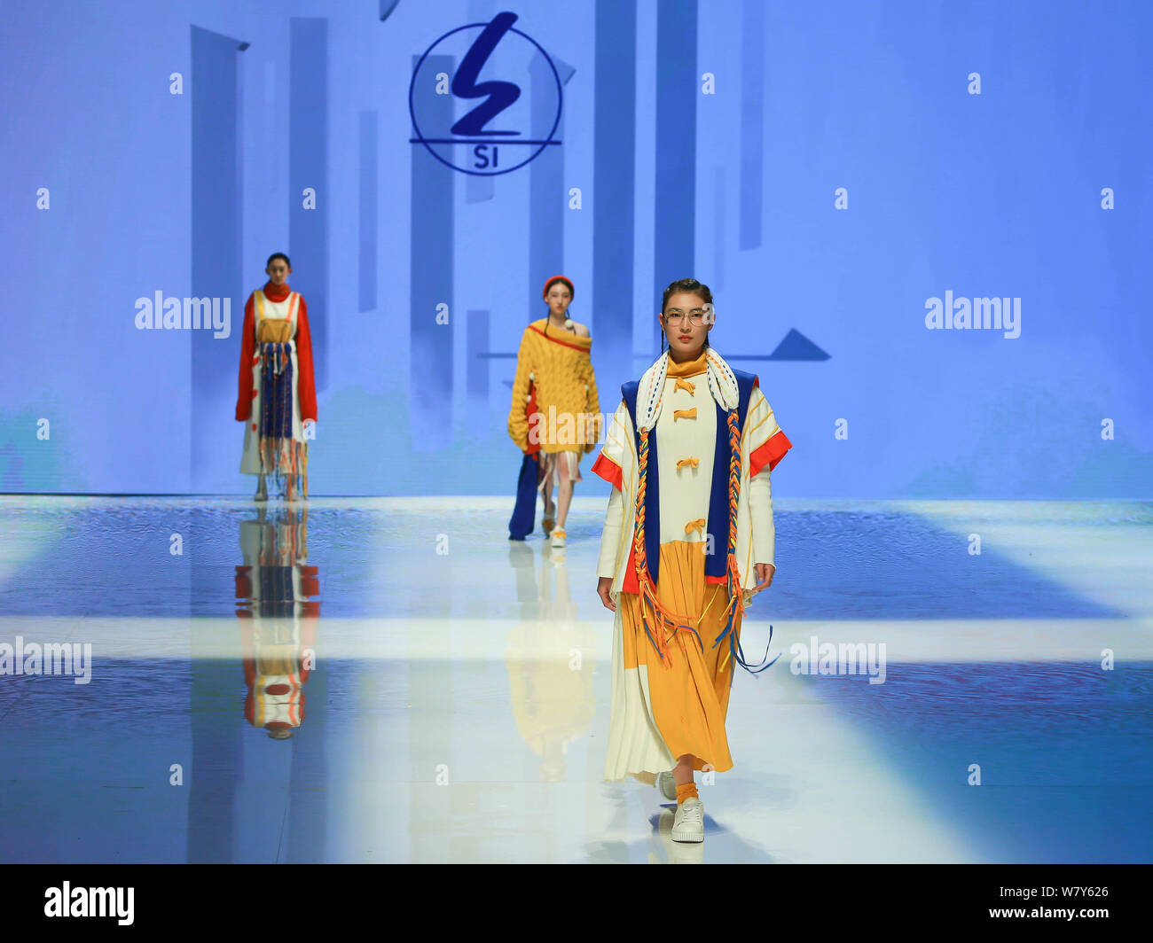 Models display creations by graduates during a fashion show for ...