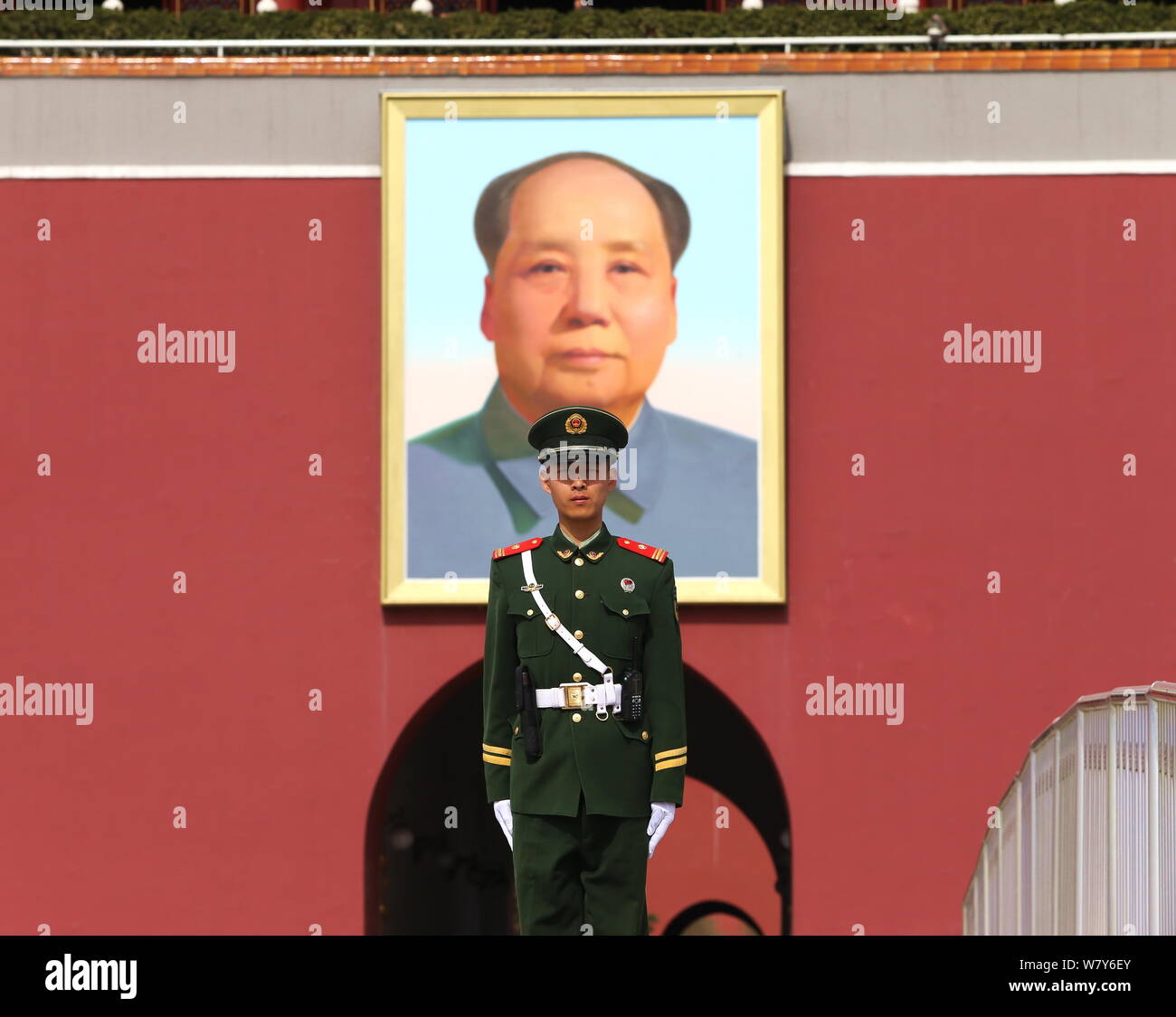 A Chinese paramilitary policeman stands guard in front of the Tian ...