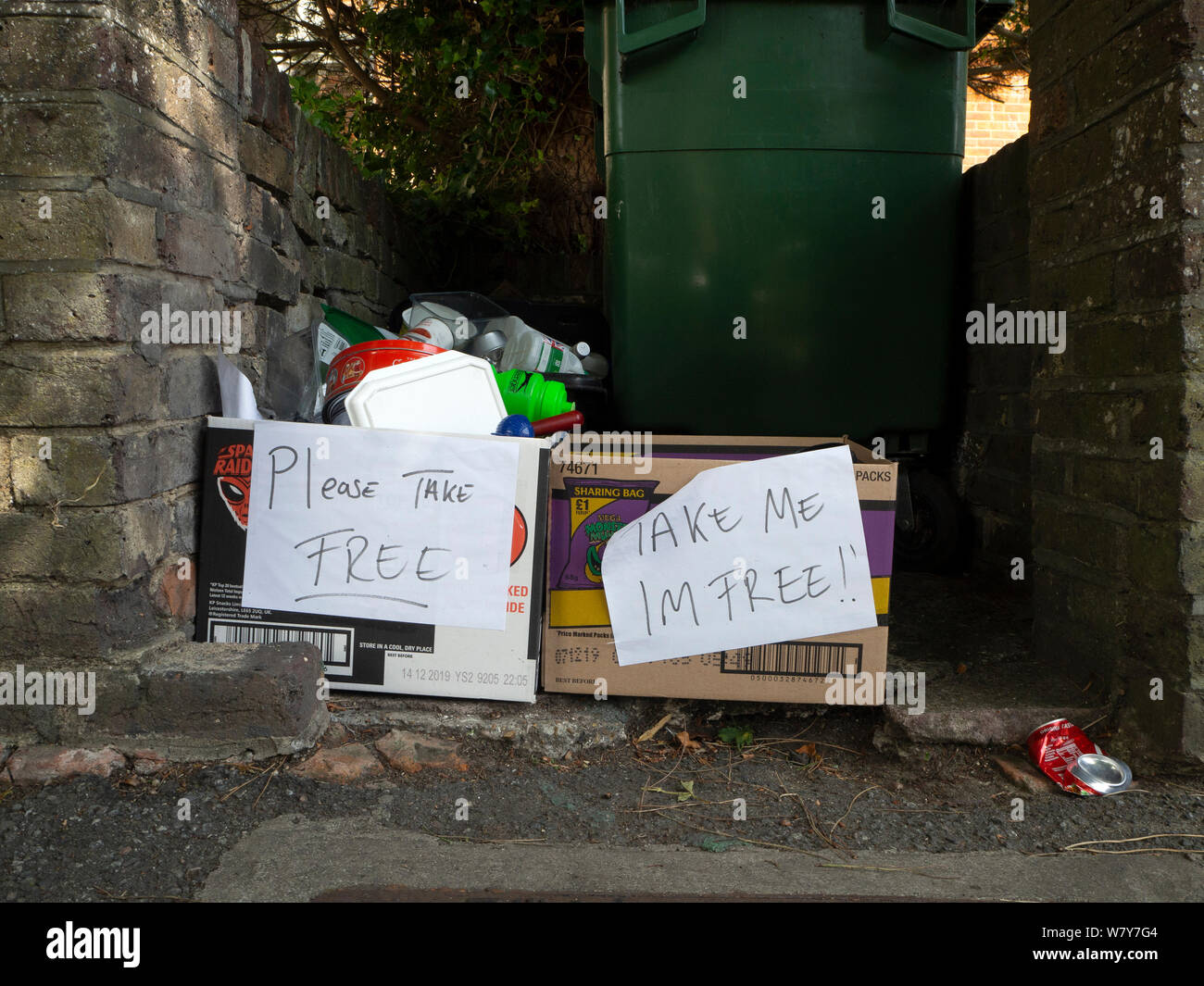 Free household items outside rubbish wheelie bins Stock Photo - Alamy