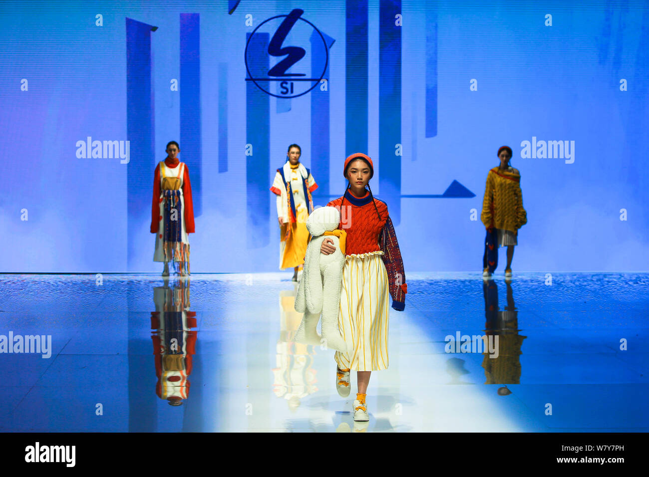 Models display creations by graduates during a fashion show for ...