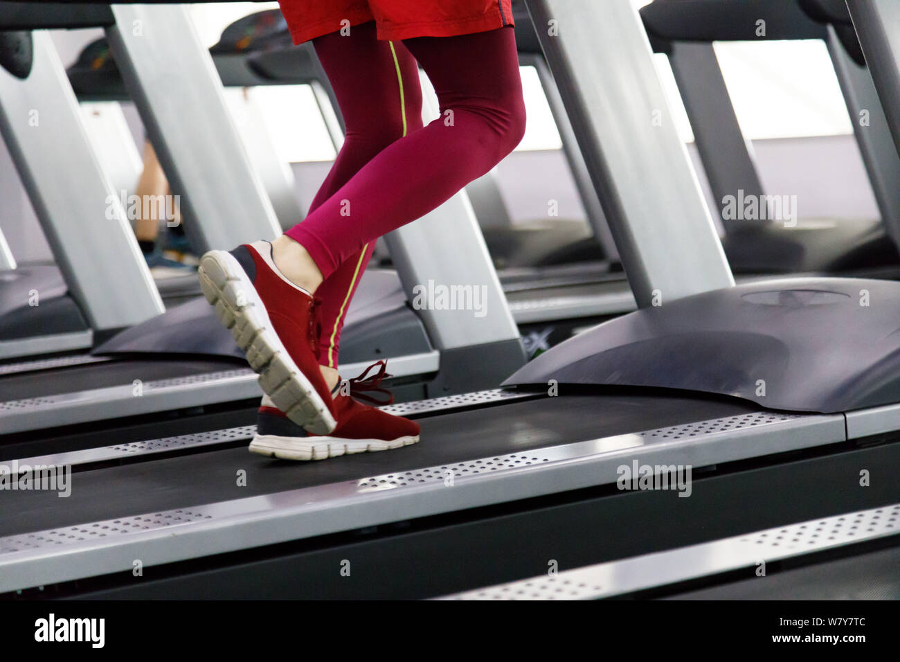 Close up view of man running in a gym on a treadmill concept for ...