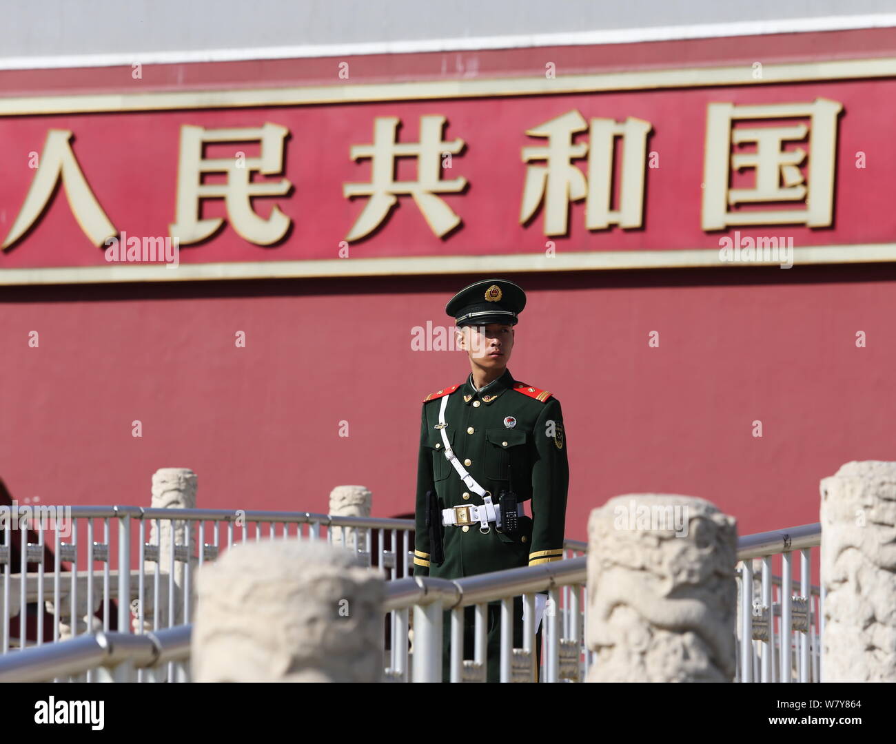 A Chinese paramilitary policeman stands guard in front of the Tian ...