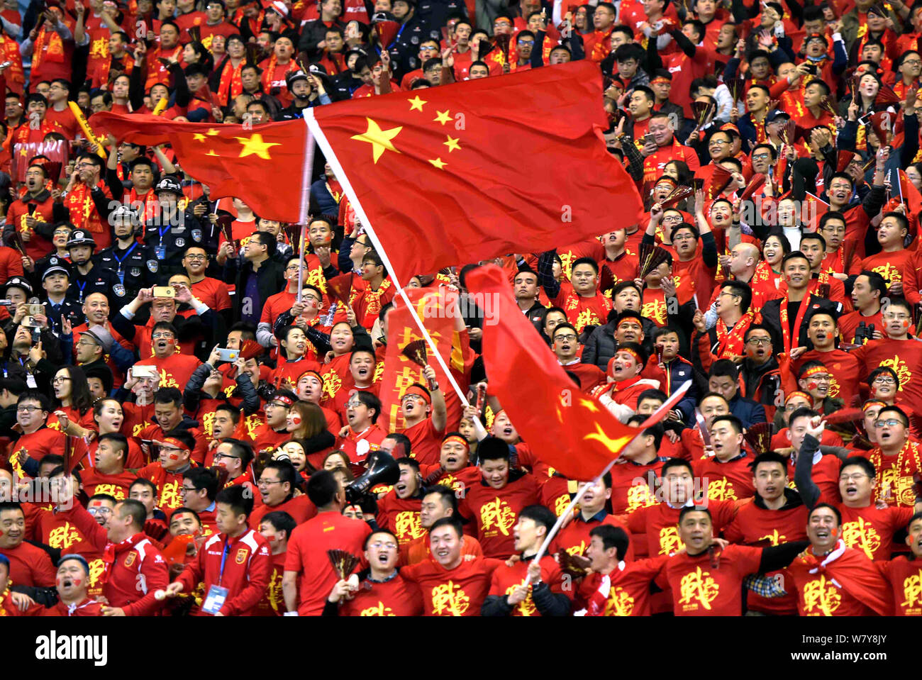 Chinese football fans hold up Chinese national flags to show his ...
