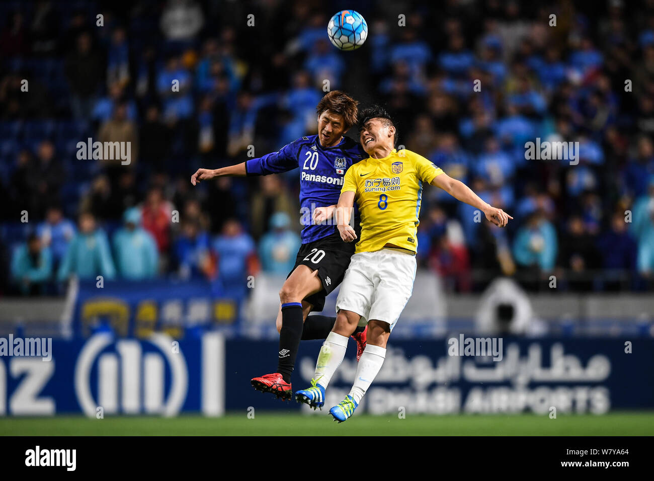 Liu Jianye of China's Jiangsu Suning, right, challenges Shun Nagasawa ...