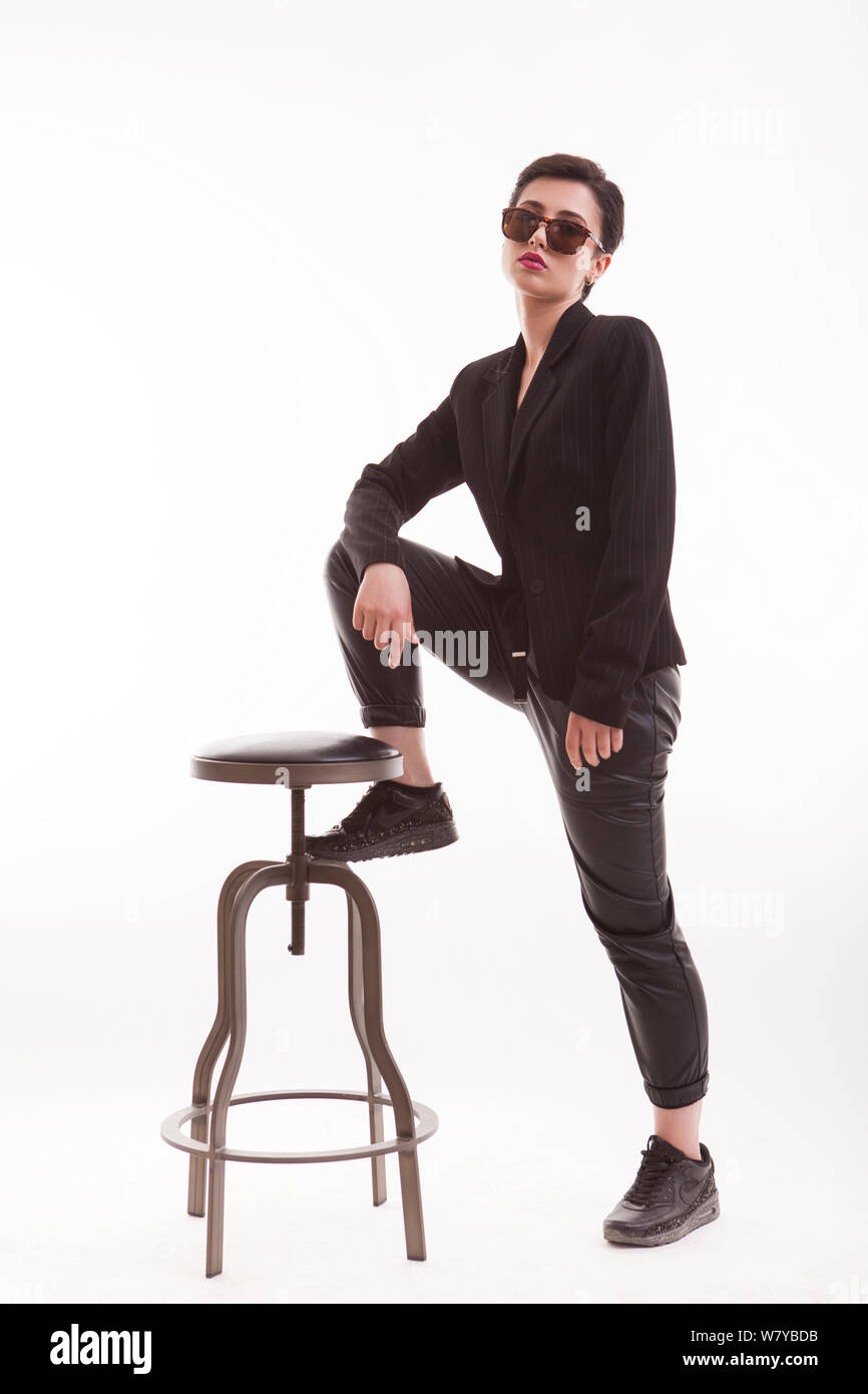 Full body portrait of fashion model in trendy outfit looking at the ...