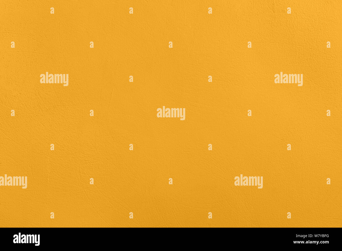 Saturated yellow colored low contrast Concrete textured background with ...