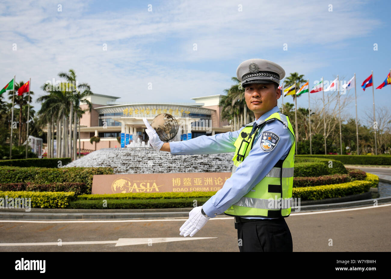 A Chinese police officer directs the traffic in front of the BFA ...