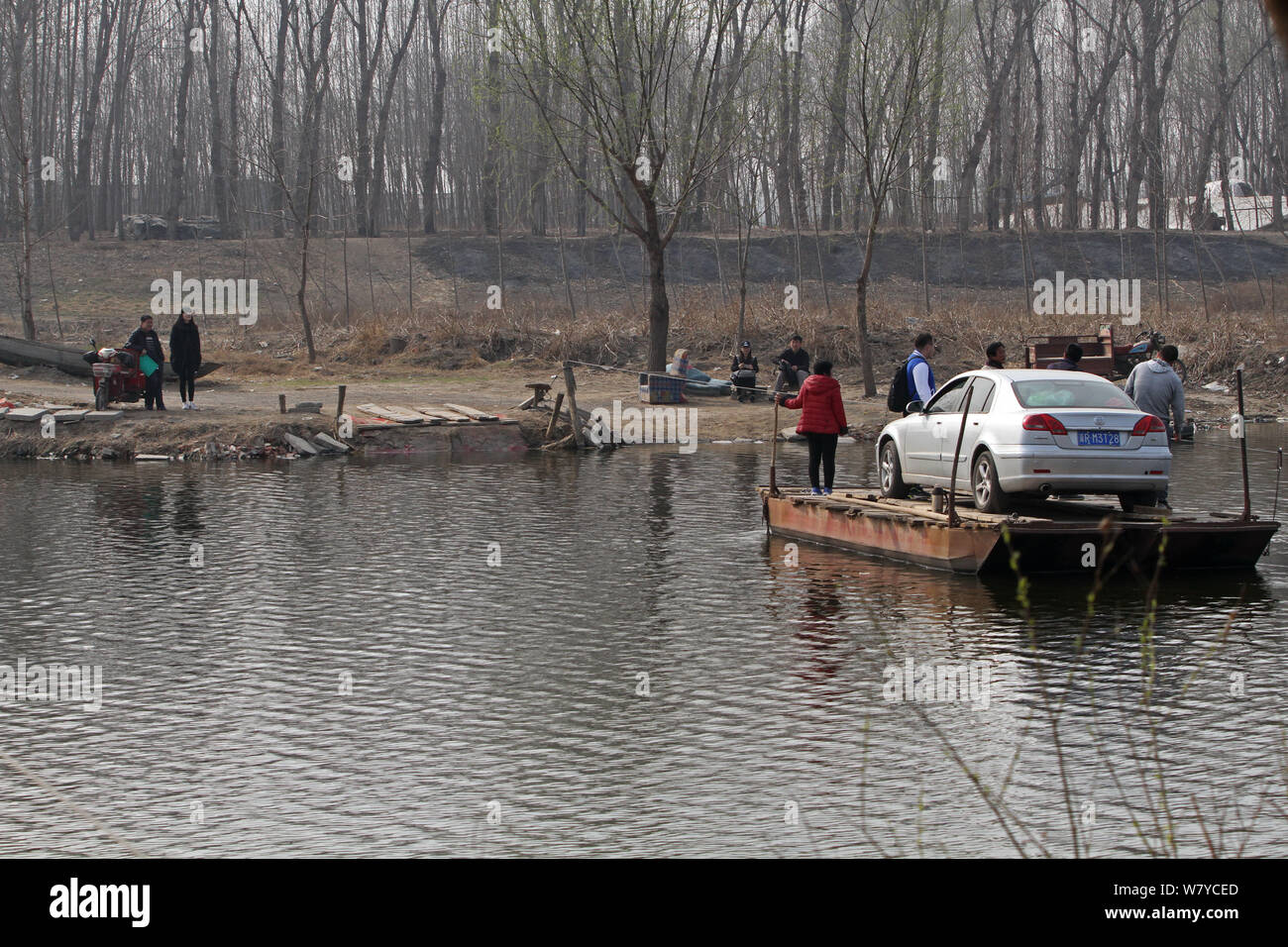 Chinese commuters and a car owner from Hebei's Yanjiao take a ferry ...
