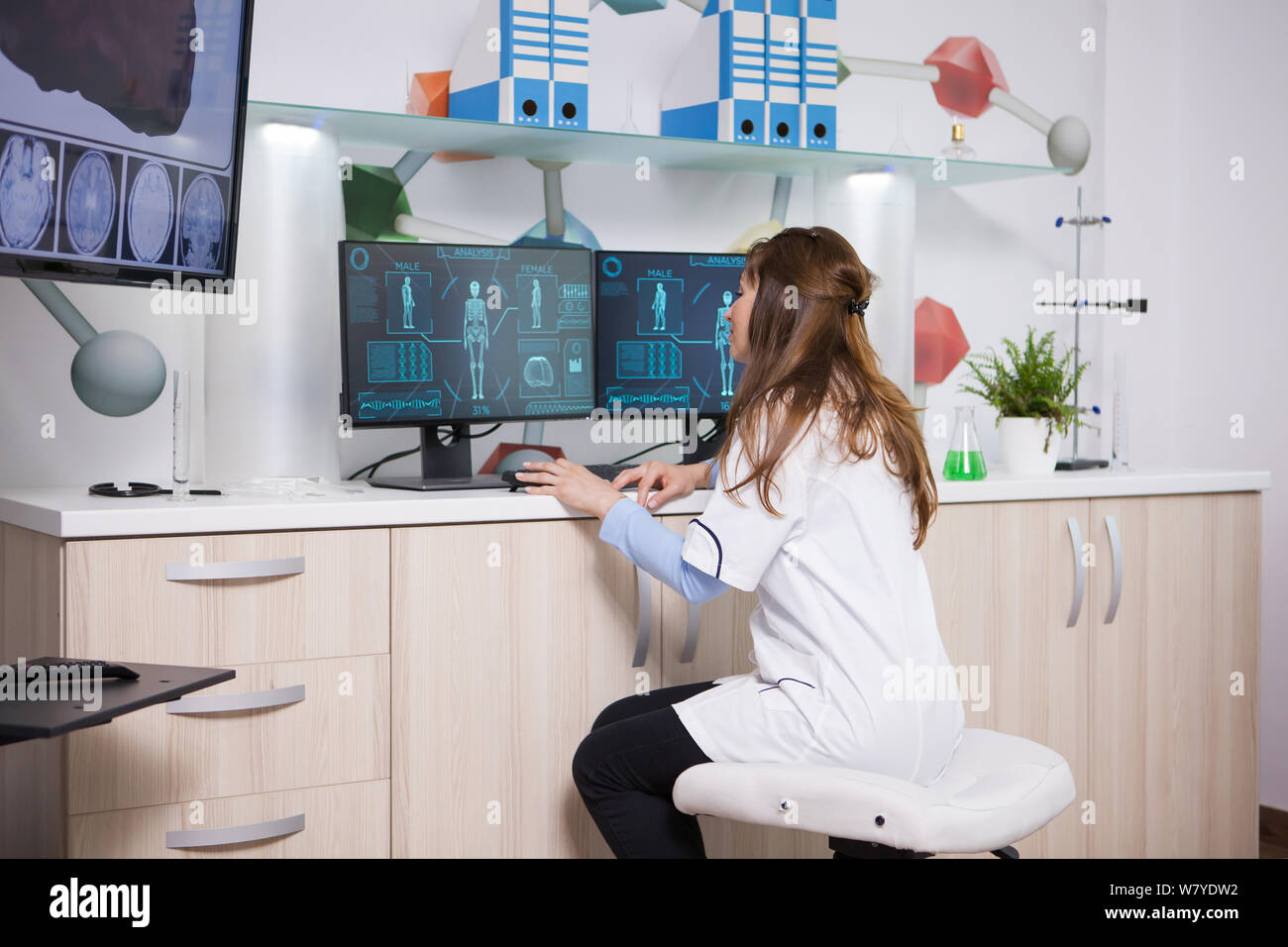 Female genetic scientist checking how food changes human body on ...