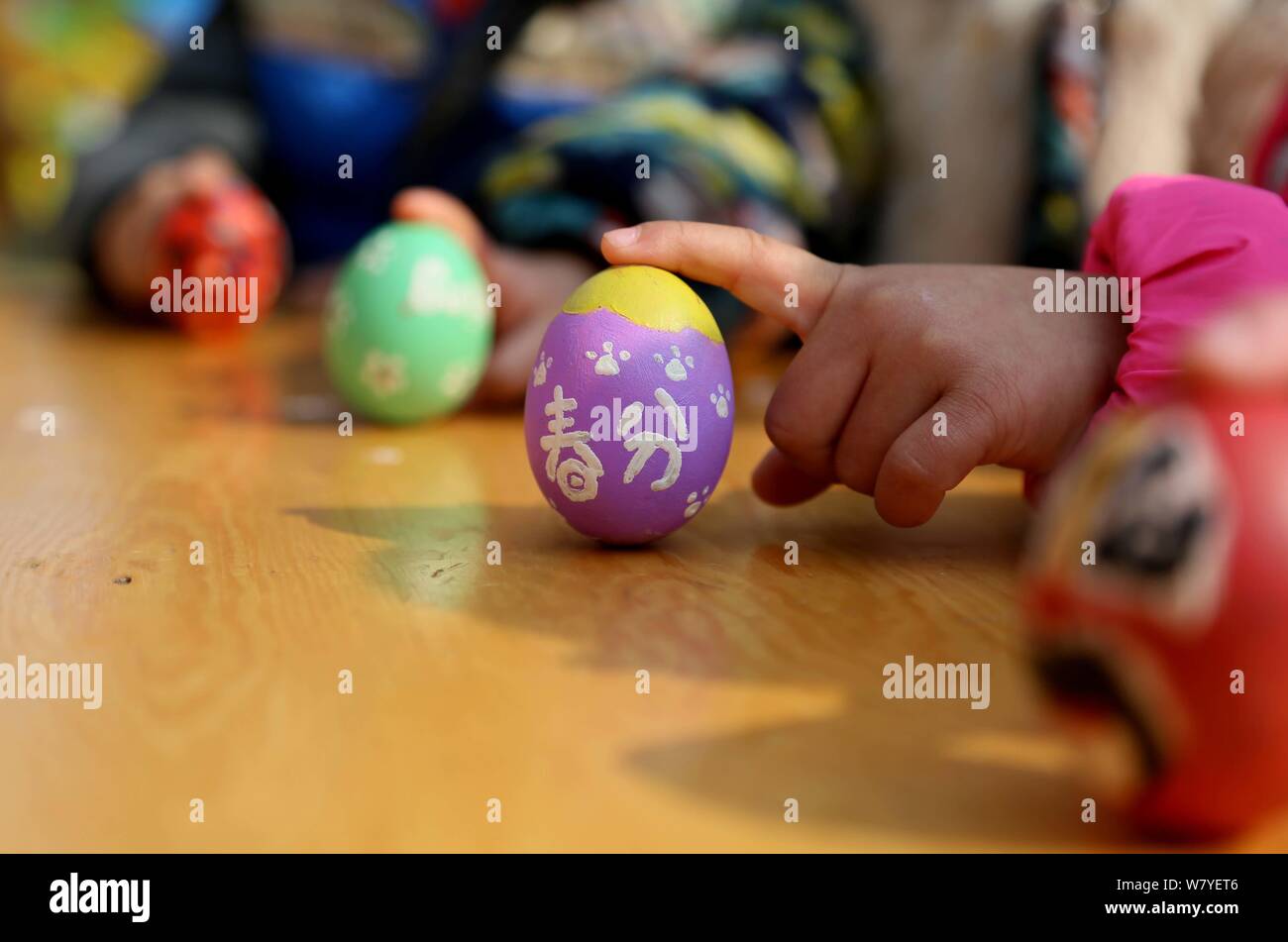 Chinese kids play with the eggs painted with Chinese characters for ...