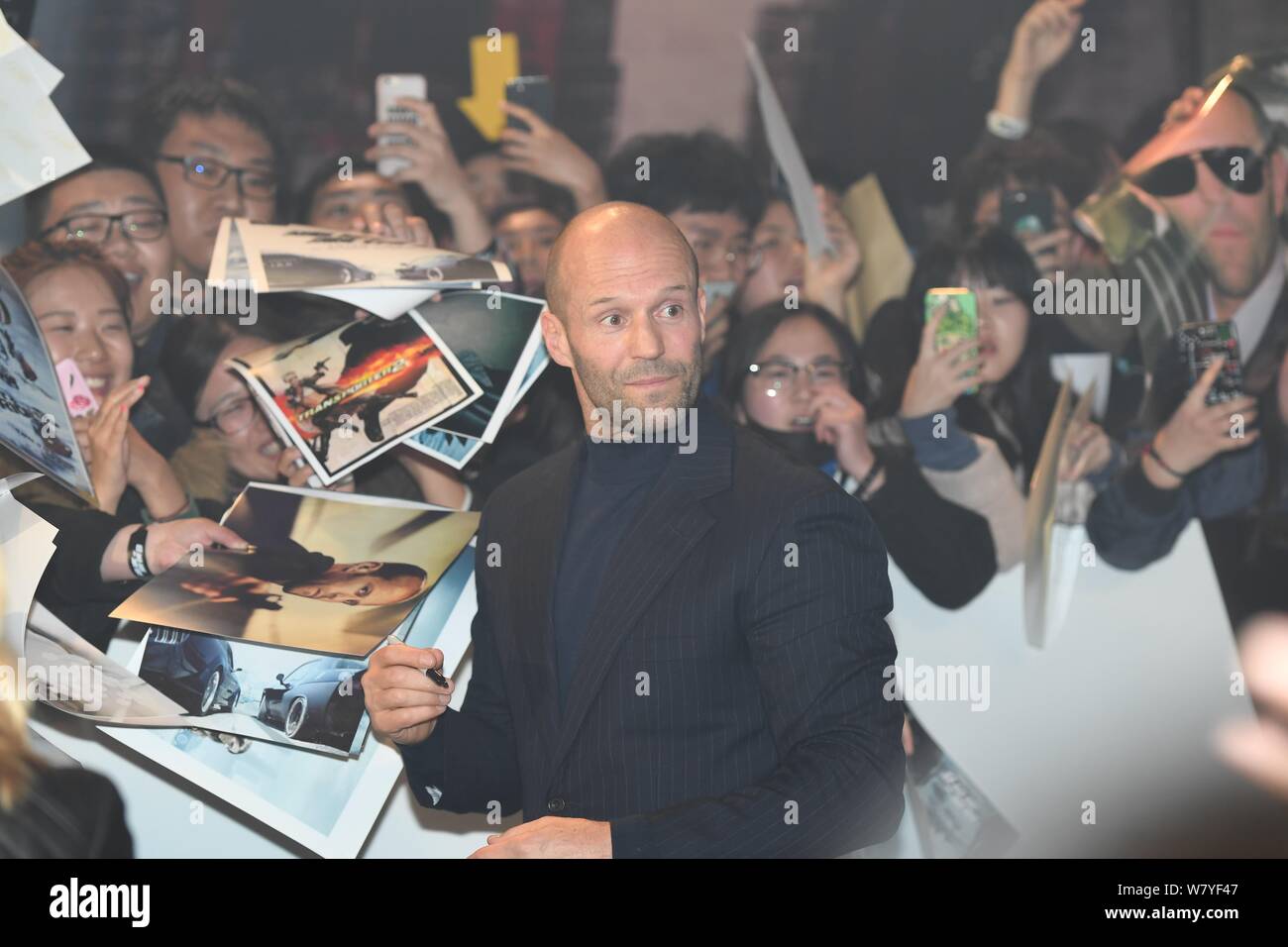 English actor Jason Statham, center, interacts with fans on the red ...