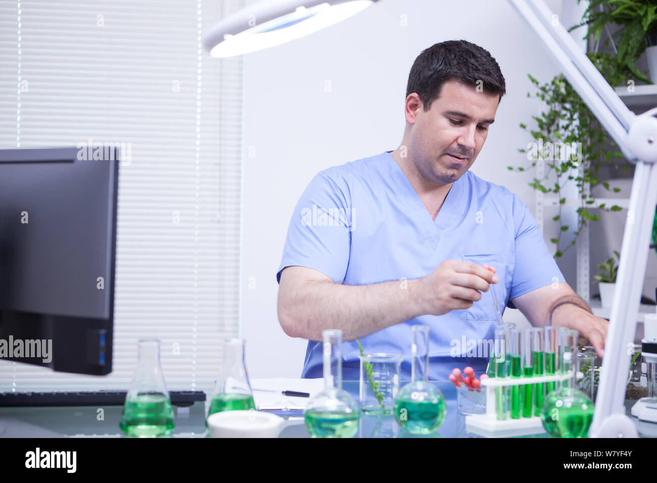 Young scientist man making test in a microbiological research lab ...