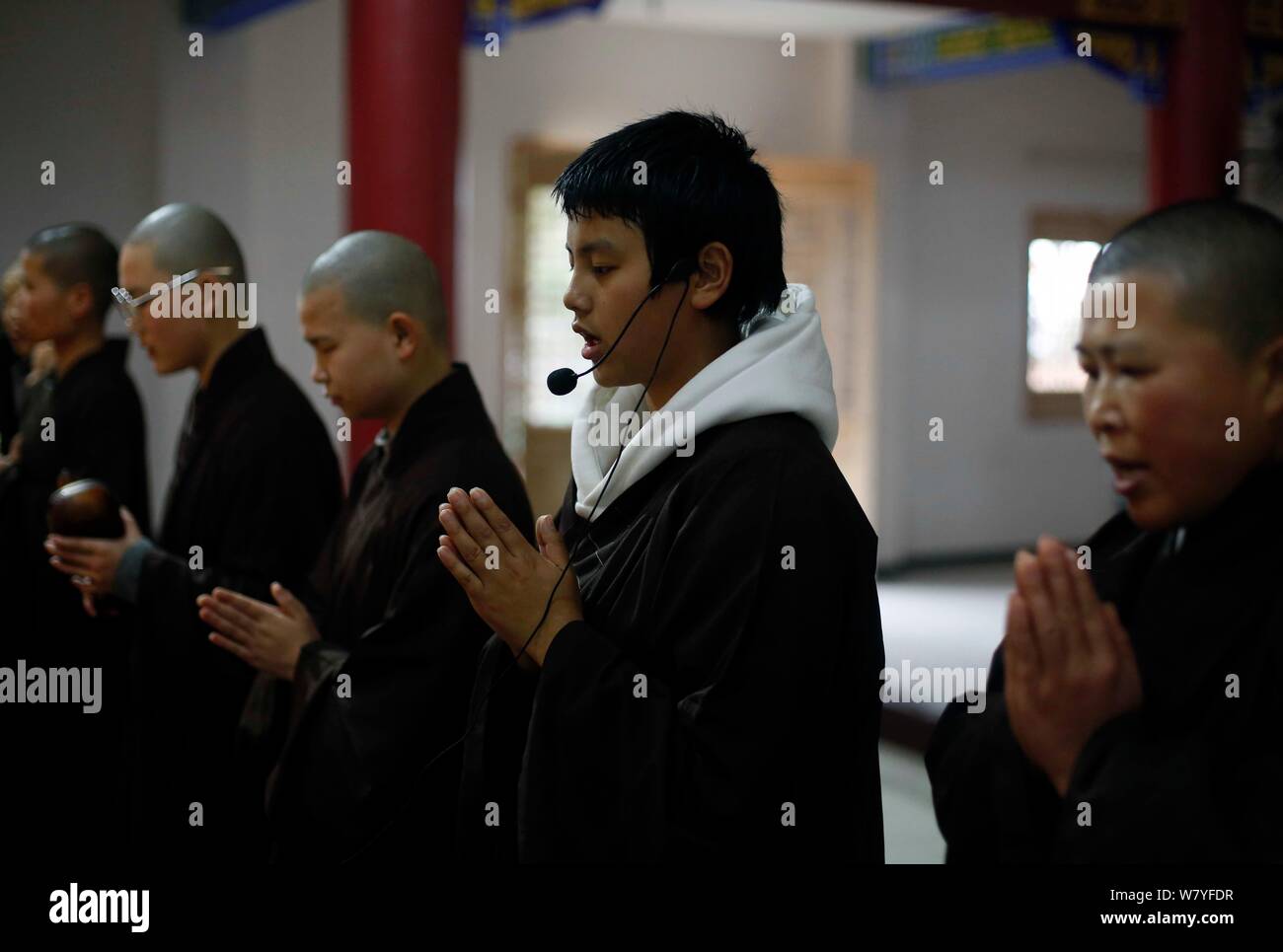 16-year-old Yanming, center, who was taken in and adopted by Master nun ...