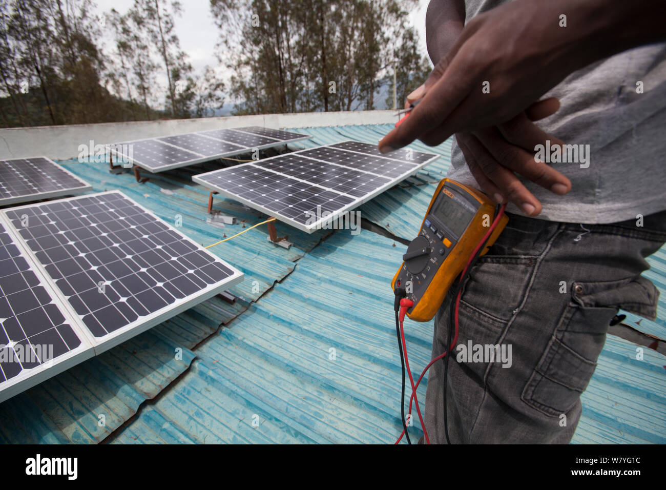 Solar energy technician with a multimeter, Rwanda, April 2014 Stock ...