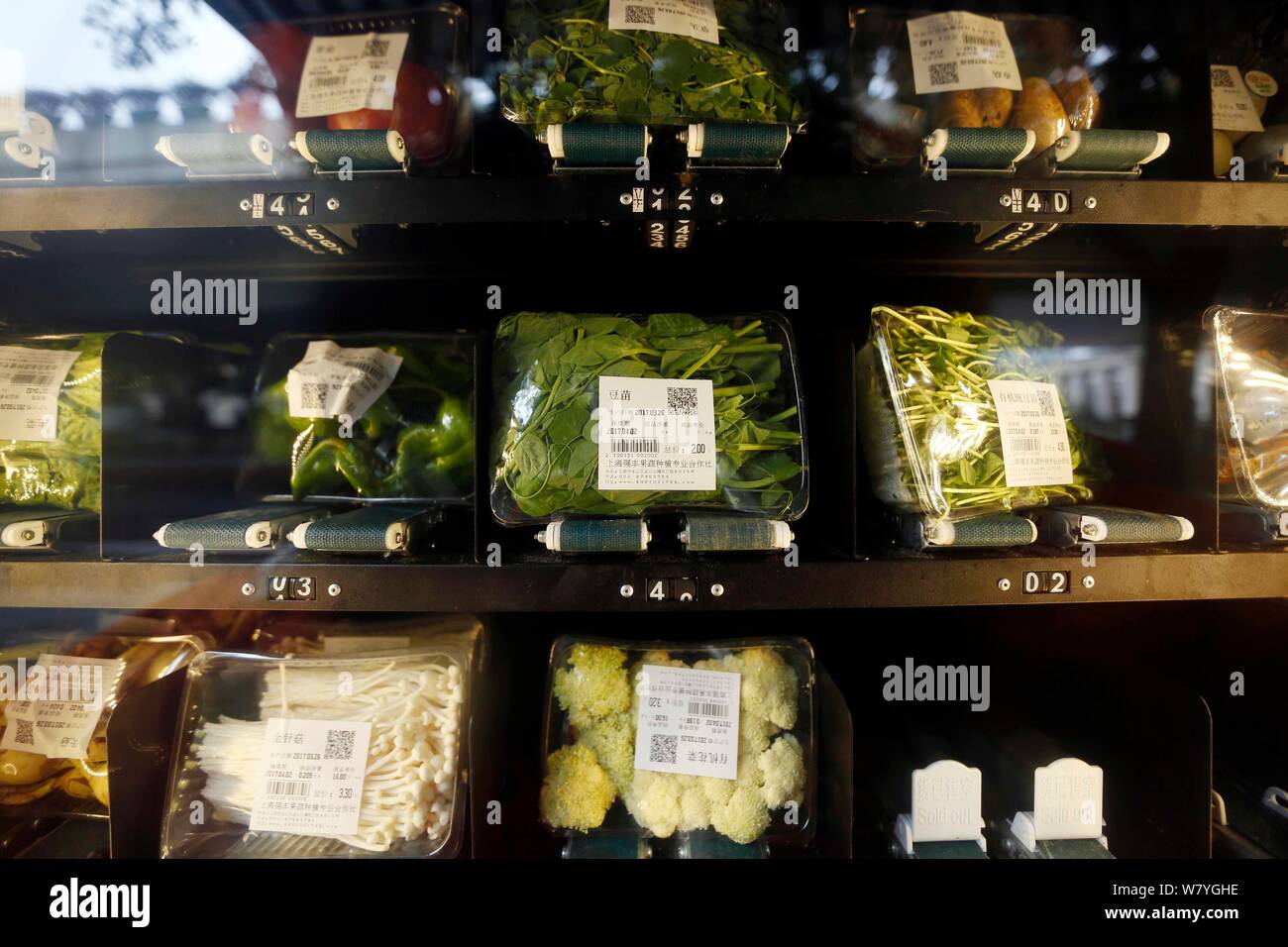 Vegetables are for sale in a vegetable vending machine on a street in ...