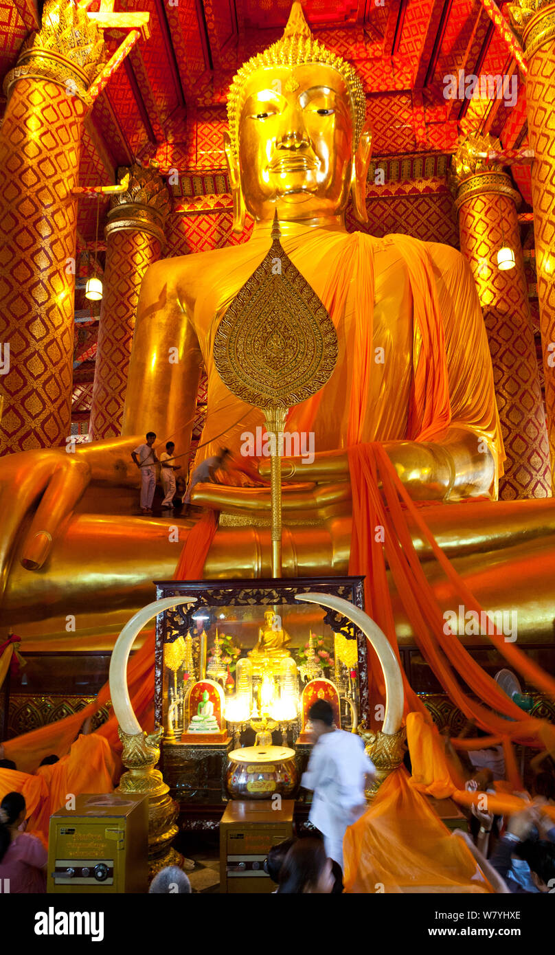 Ceremony adorning golden statue of the Buddha (in Calling the Earth to ...