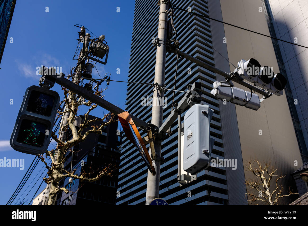 Traffic light and pole in downtown Tokyo, Japan with a high rise ...