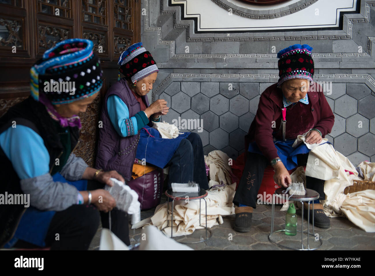Chinese female elders of the Bai ethnic group tie sections of white ...