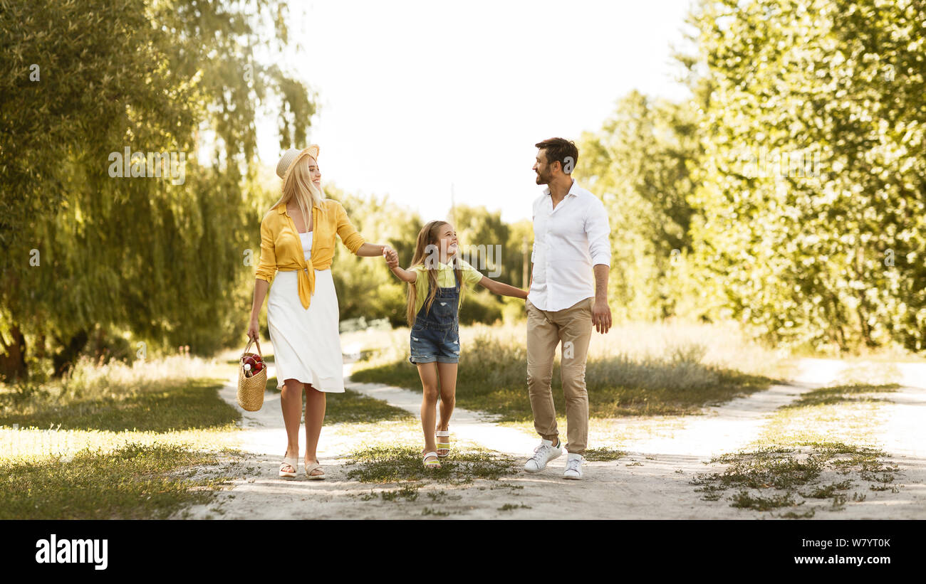 Young parents resting with daughter in countryside Stock Photo - Alamy