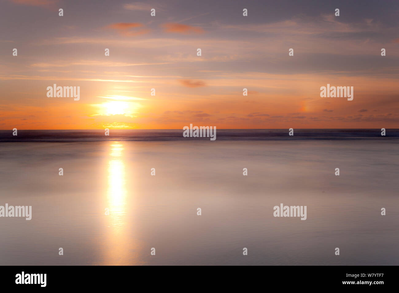 Sea surf on beach at sunset, slow shutter speed, Sennen Cove, Cornwall ...