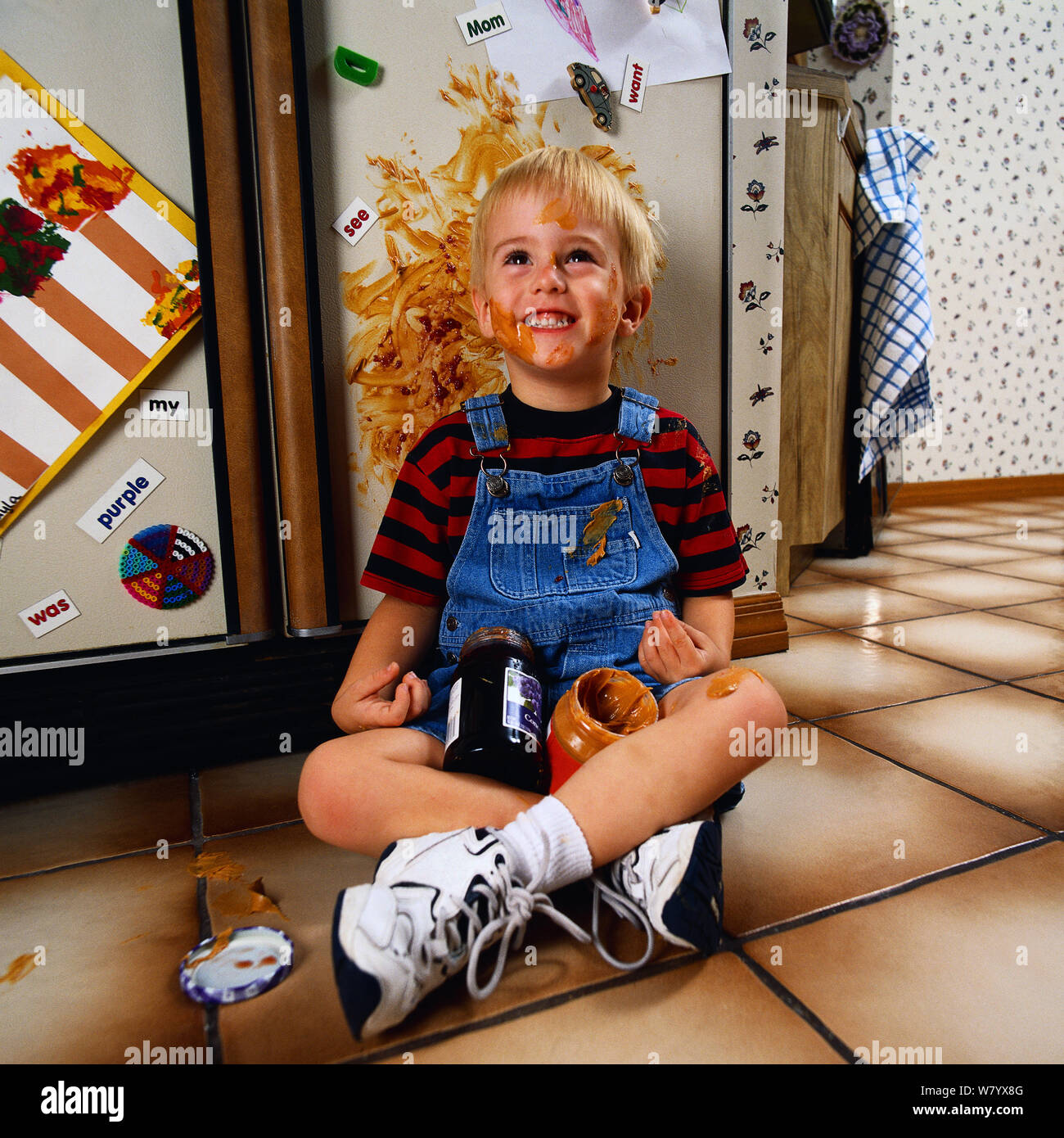 A child reaching for food and making a mess spilling everything Stock ...