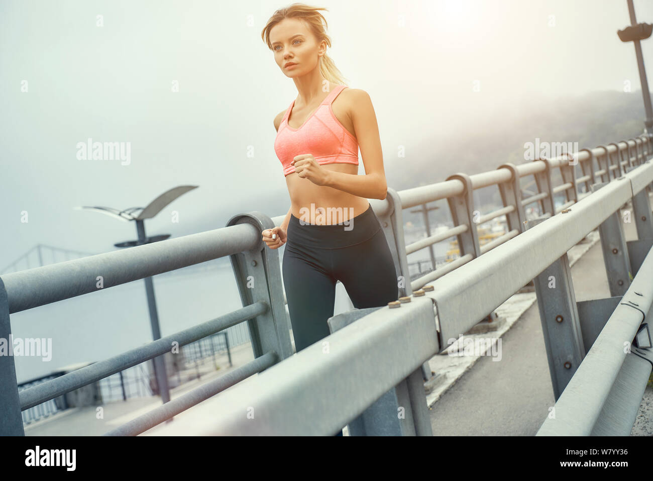 Attractive blonde woman running on hi-res stock photography and images ...