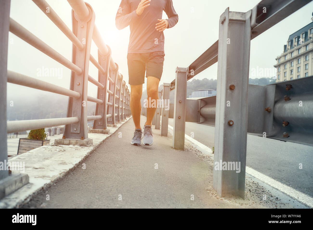 Can't stop tu run. Cropped photo of a man in sports clothing jogging on ...