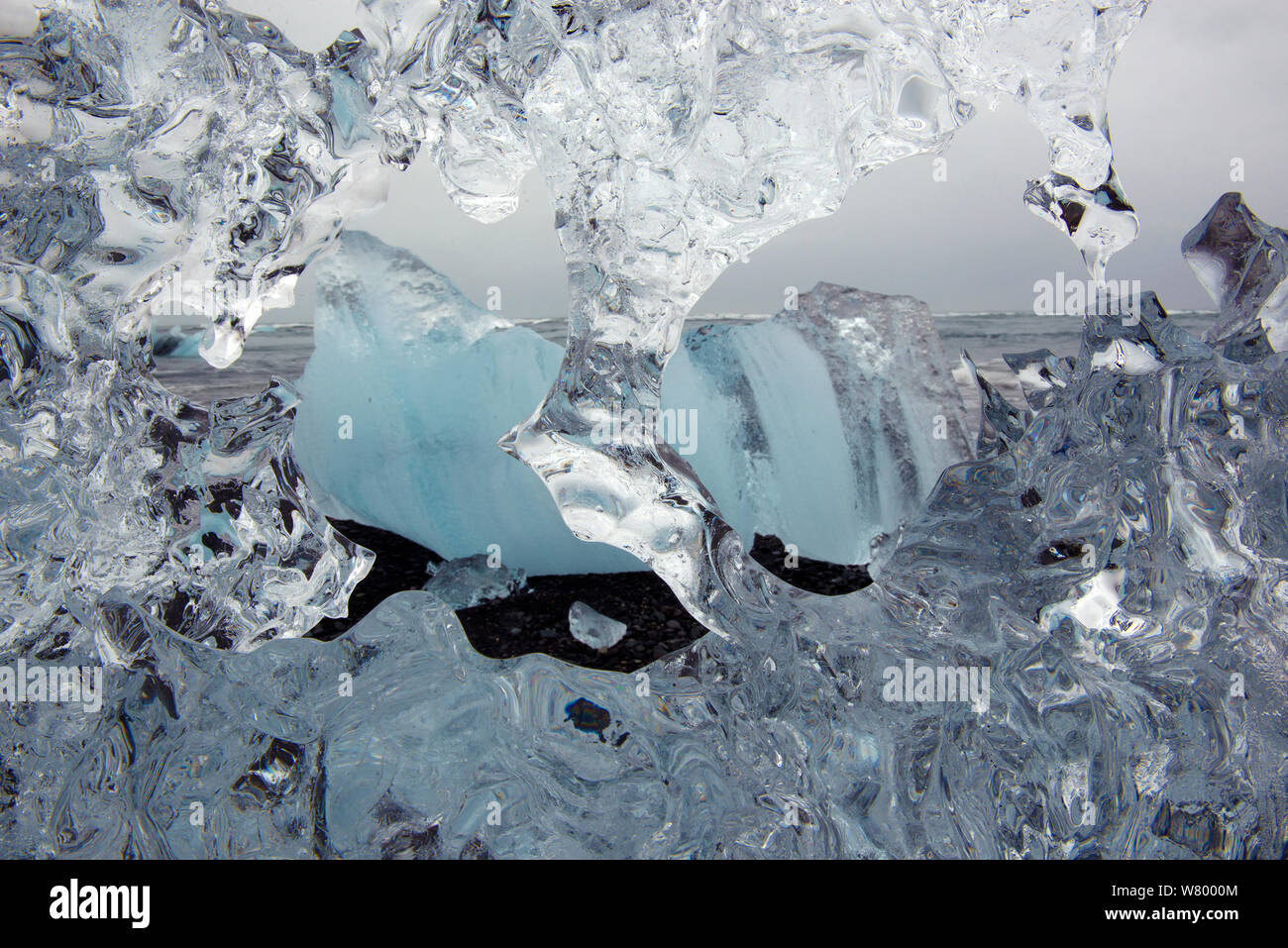 Iceberg viewed through partially melted ice formation, Jokulsarlon ...