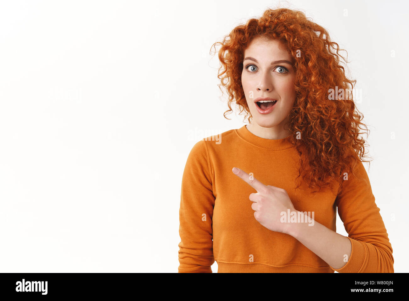 Excited Curious Redhead Curly Haired Gorgeous Woman Looking Questioned