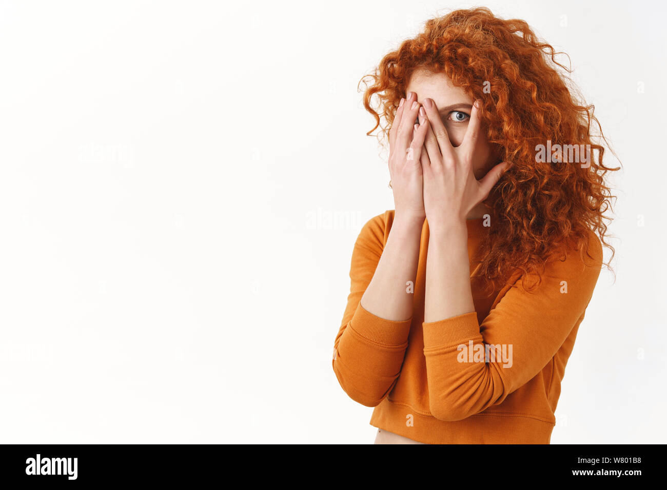 Hiding face behind fingers hi-res stock photography and images - Alamy