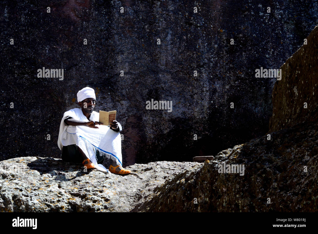 Devout Christian in traditional robes inside courtyard of Northwestern ...