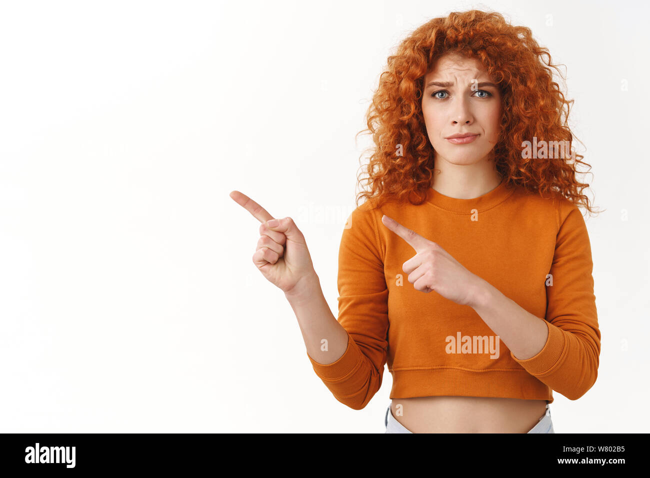 Displeased Upset Stylish Redhead Curly Haired Woman Frowning Grimacing