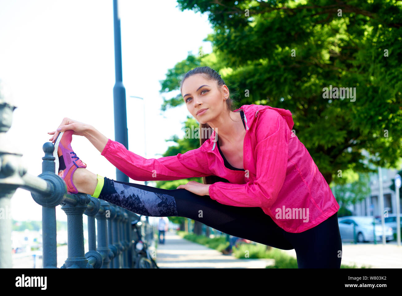 Shot of young woman stretching after run in the city Stock Photo - Alamy