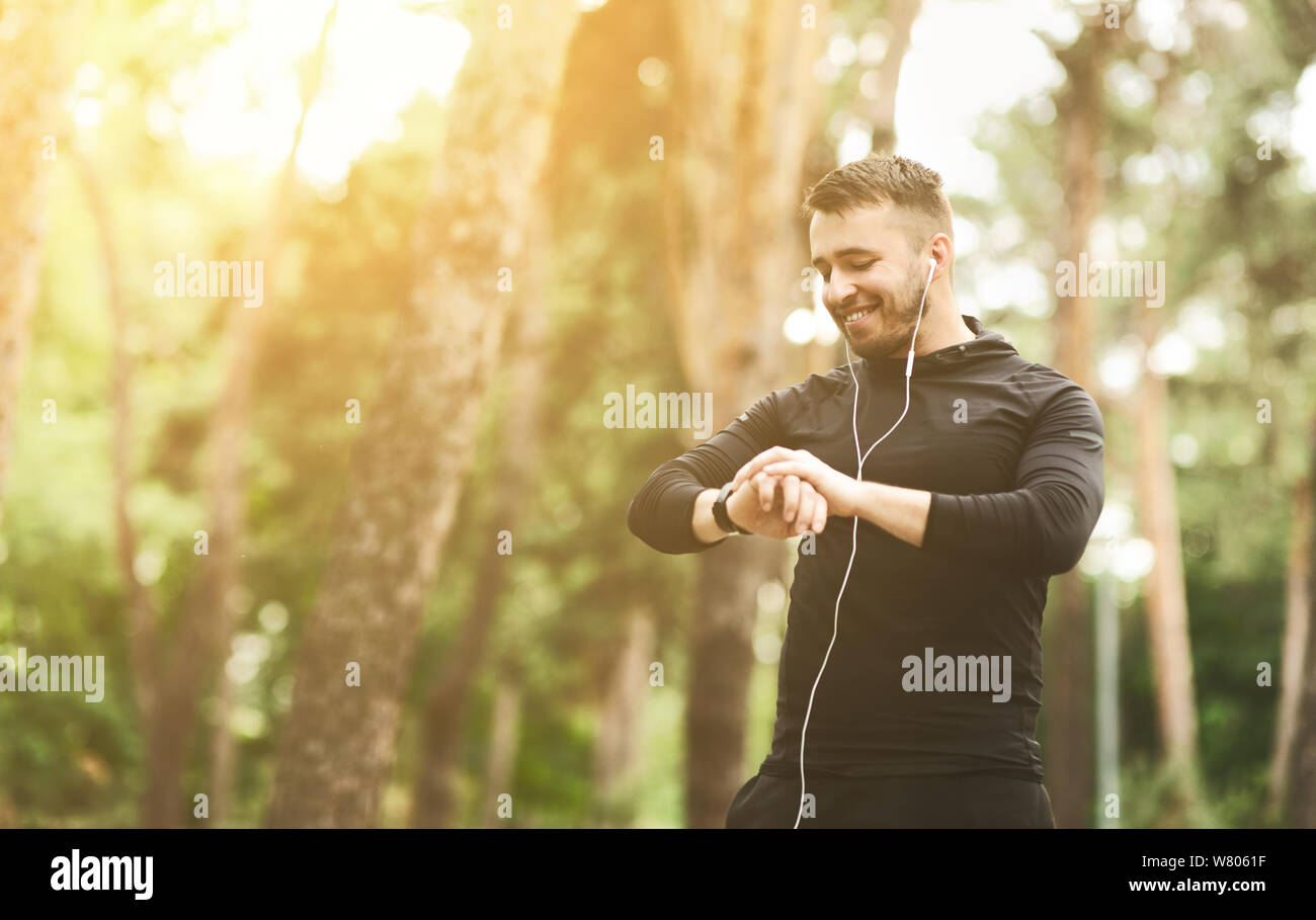 Man checking performance on smartwatch hi-res stock photography and ...