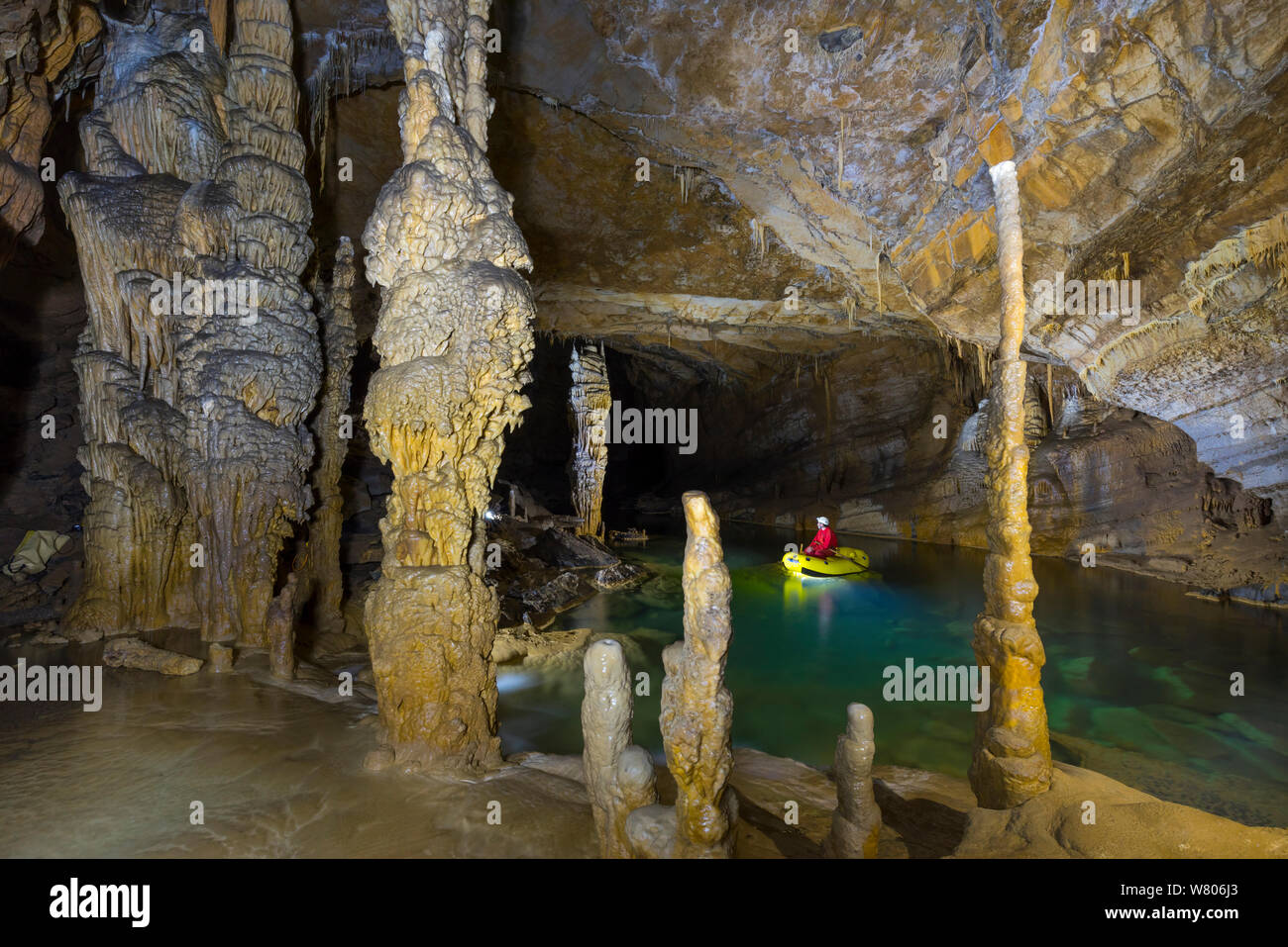 Man in small rigid inflatable boat, Cross Cave (Krizna Jama) under ...