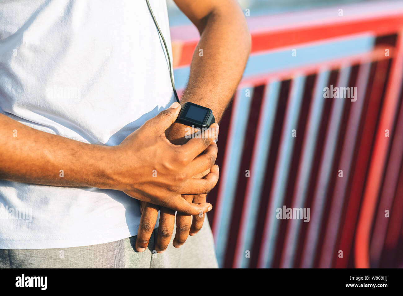 Hands of black guy checking heart rate on smartwatch Stock Photo - Alamy