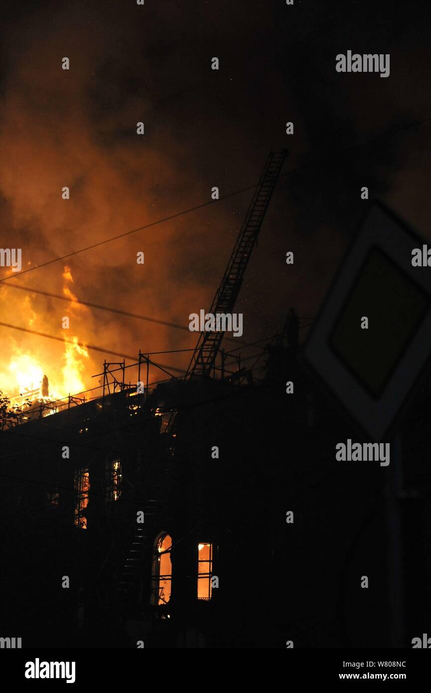 Big fire at night. Old building burns at night Stock Photo - Alamy