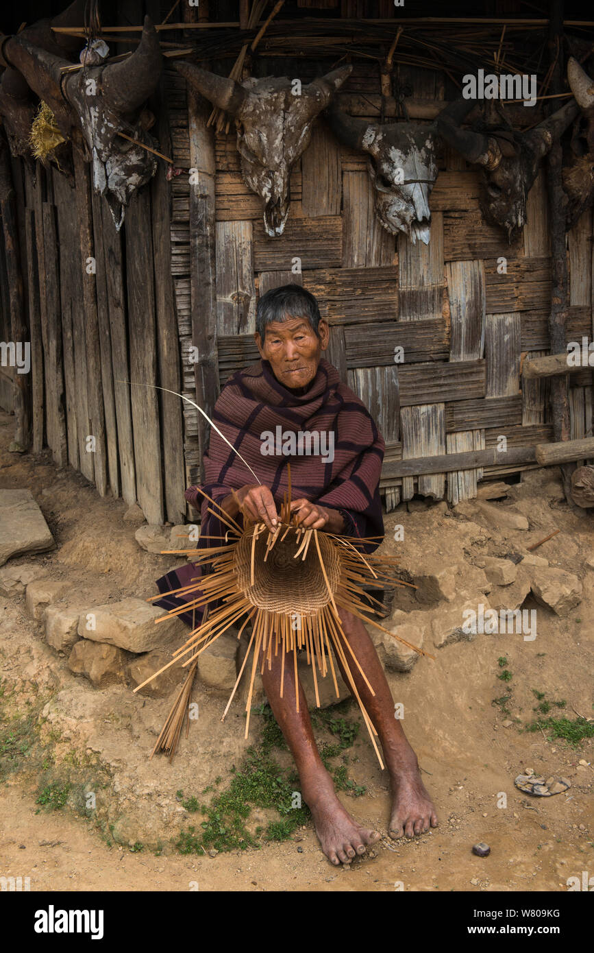 Chang Naga man making basket, Chang Naga man, Tuensang district ...