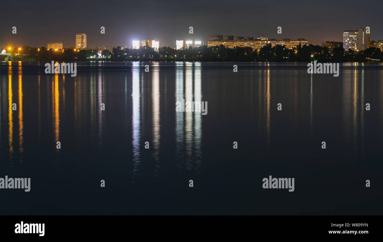 Skyline panorama of night city with lights reflection over water Stock ...