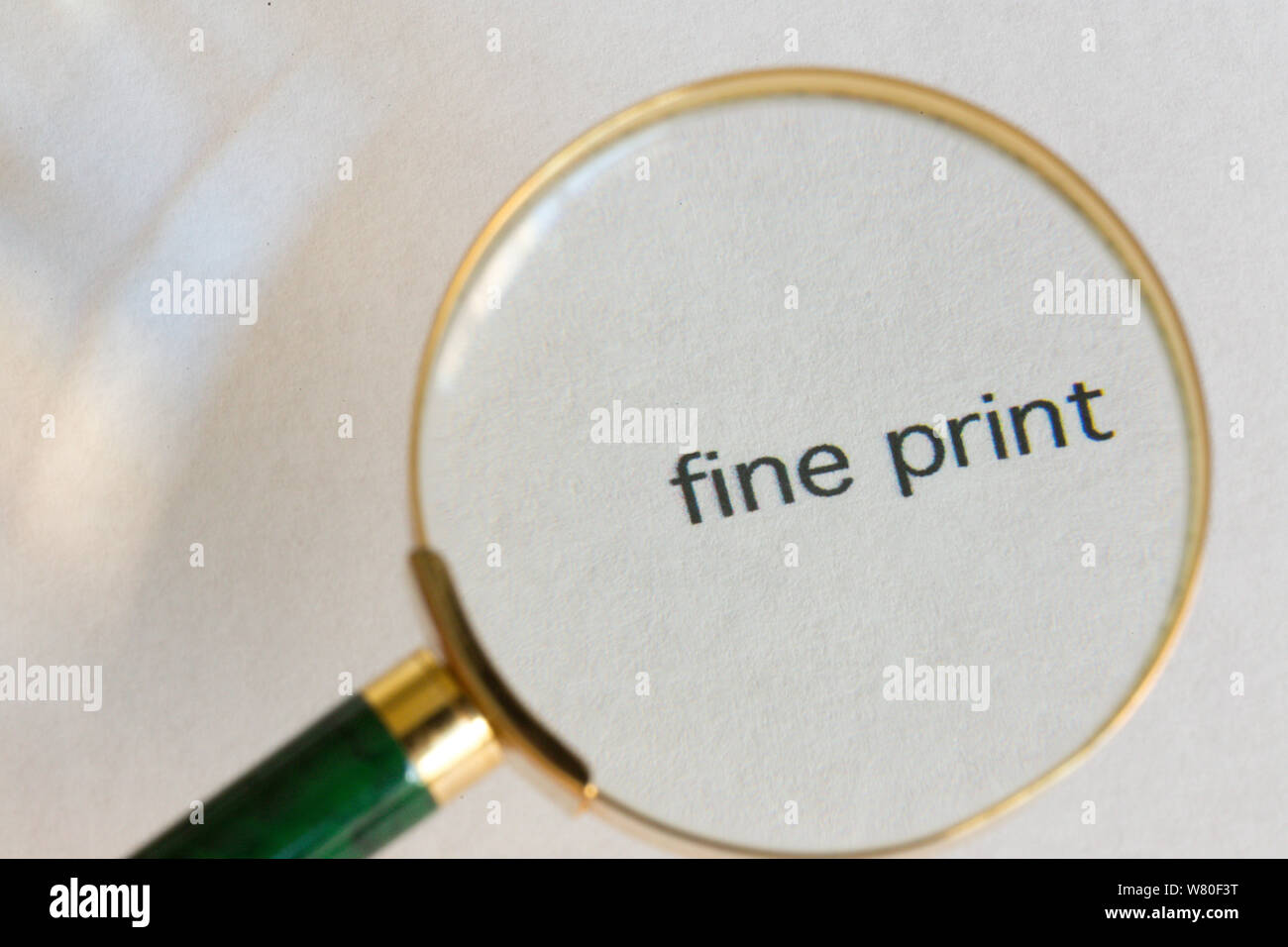 Close Up Still Life of fine print warning Under a Magnifying Glass, USA ...