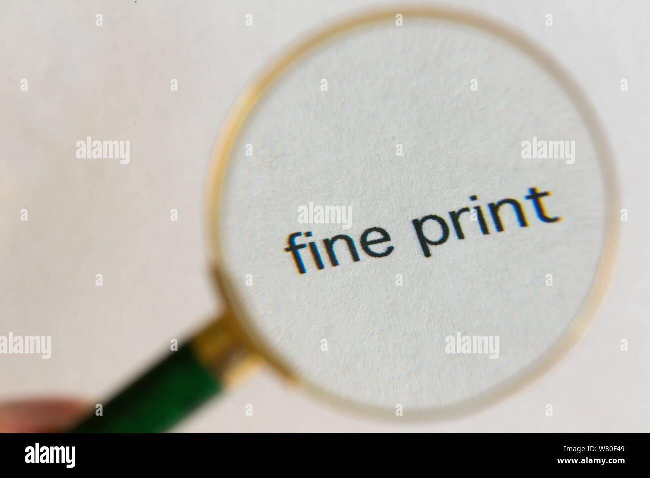 Close Up Still Life of fine print warning Under a Magnifying Glass, USA ...