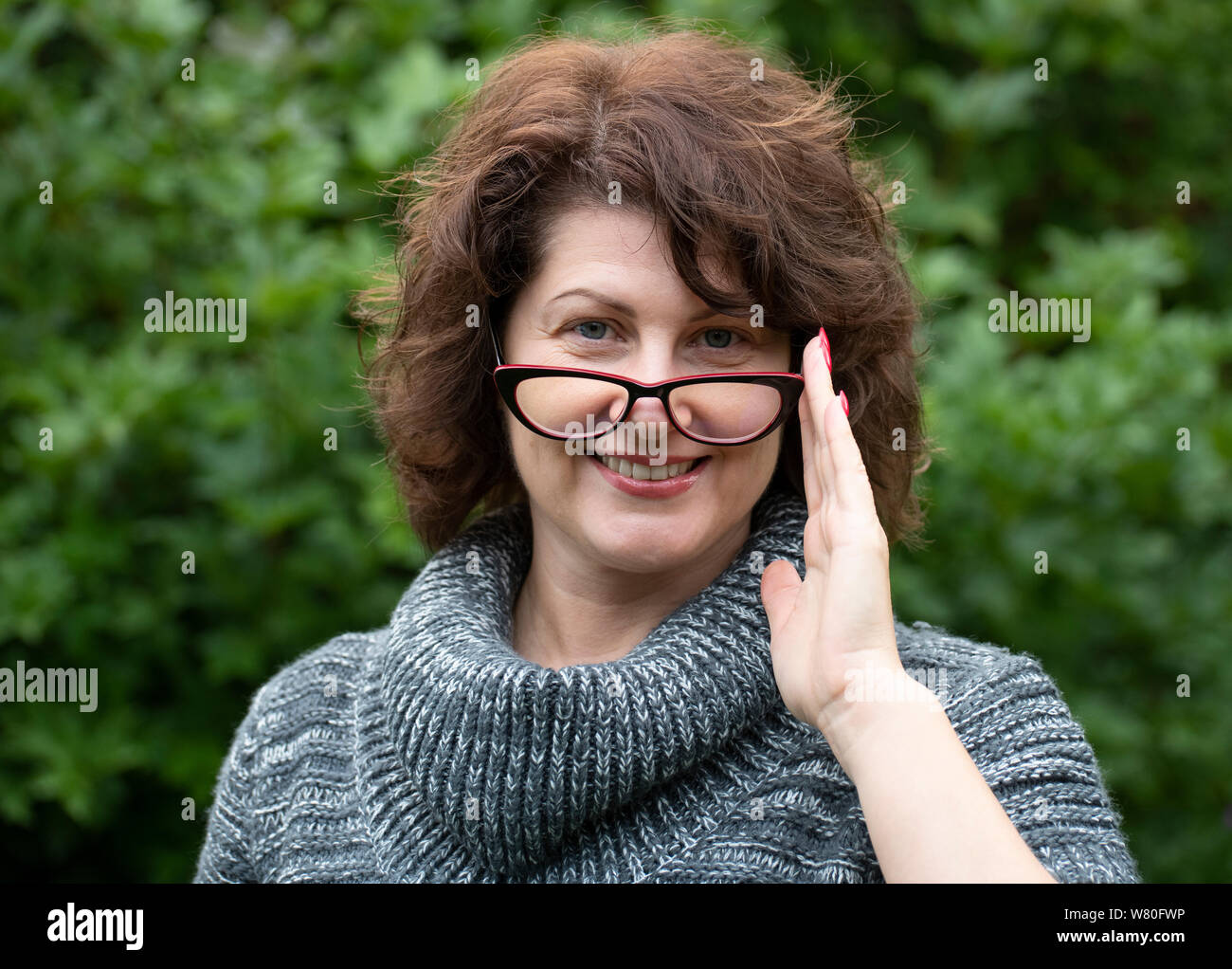 Woman in red sweater glasses hi-res stock photography and images - Alamy