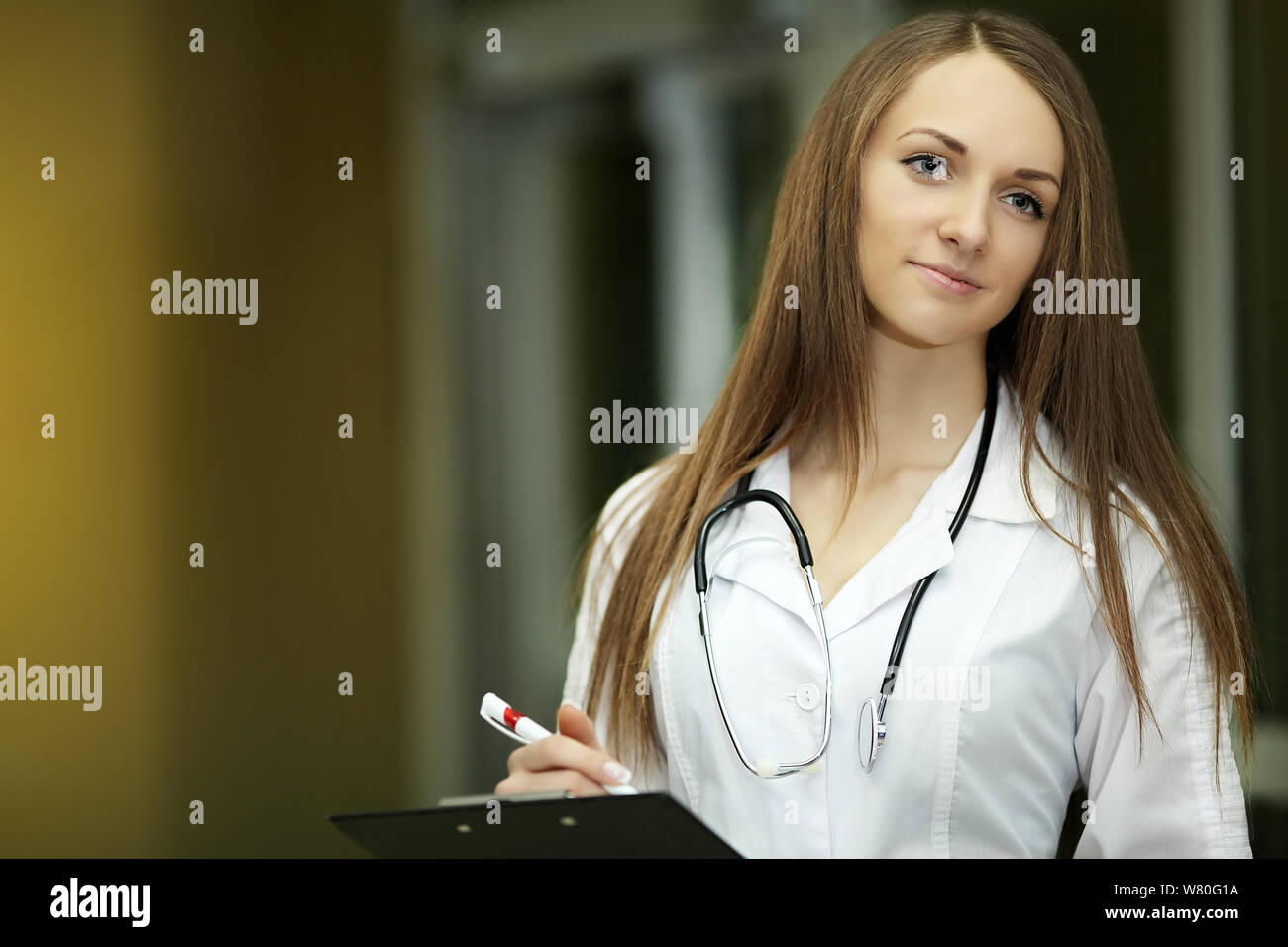 Smiling family doctor with a stethoscope. Healthcare. Young woman ...