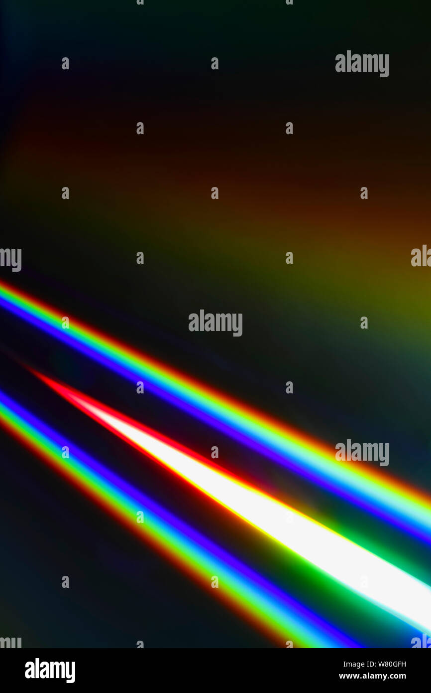 Beams of light refracting and creating a rainbow spectrum of colours ...