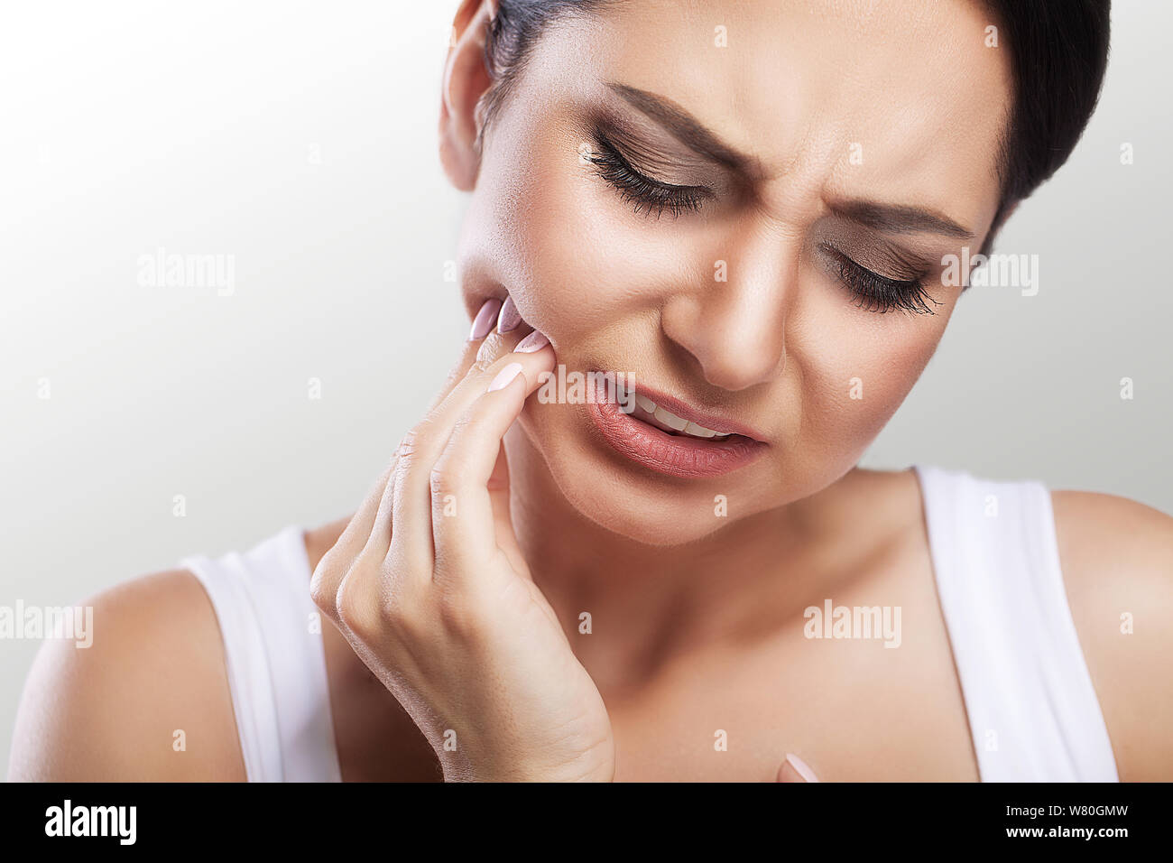Teeth Problem. Woman Feeling Tooth Pain. Closeup Of A Beautiful Sad ...